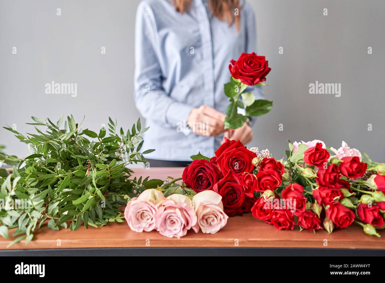 Floral shop concept . Florist woman creates flower arrangement ...