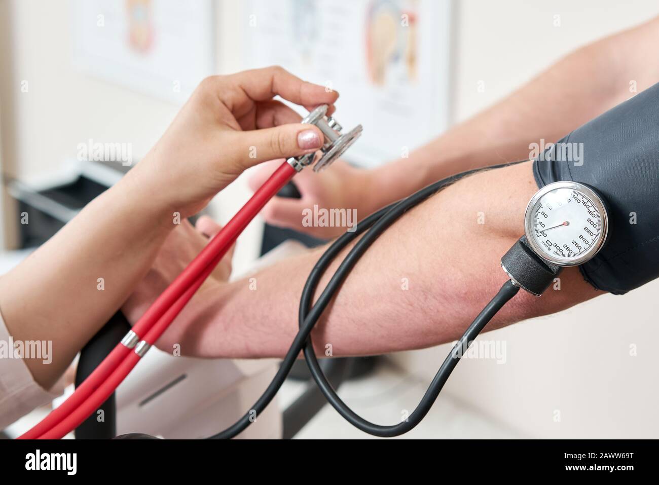 The nurse measures arterial tension. Man patient, pedaling on a bicycle ...