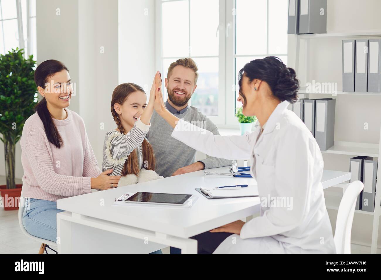 Happy family on a visit to the doctor in the office of a doctor Stock ...