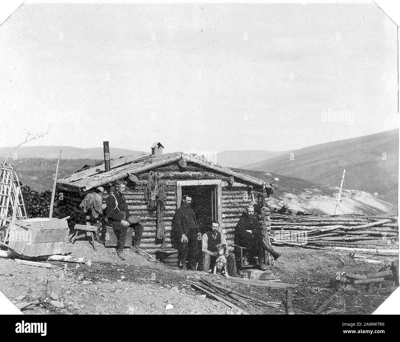 Four men and dog in front of Roper Cabin, Cheechako Hill, May 13, 1900 ...