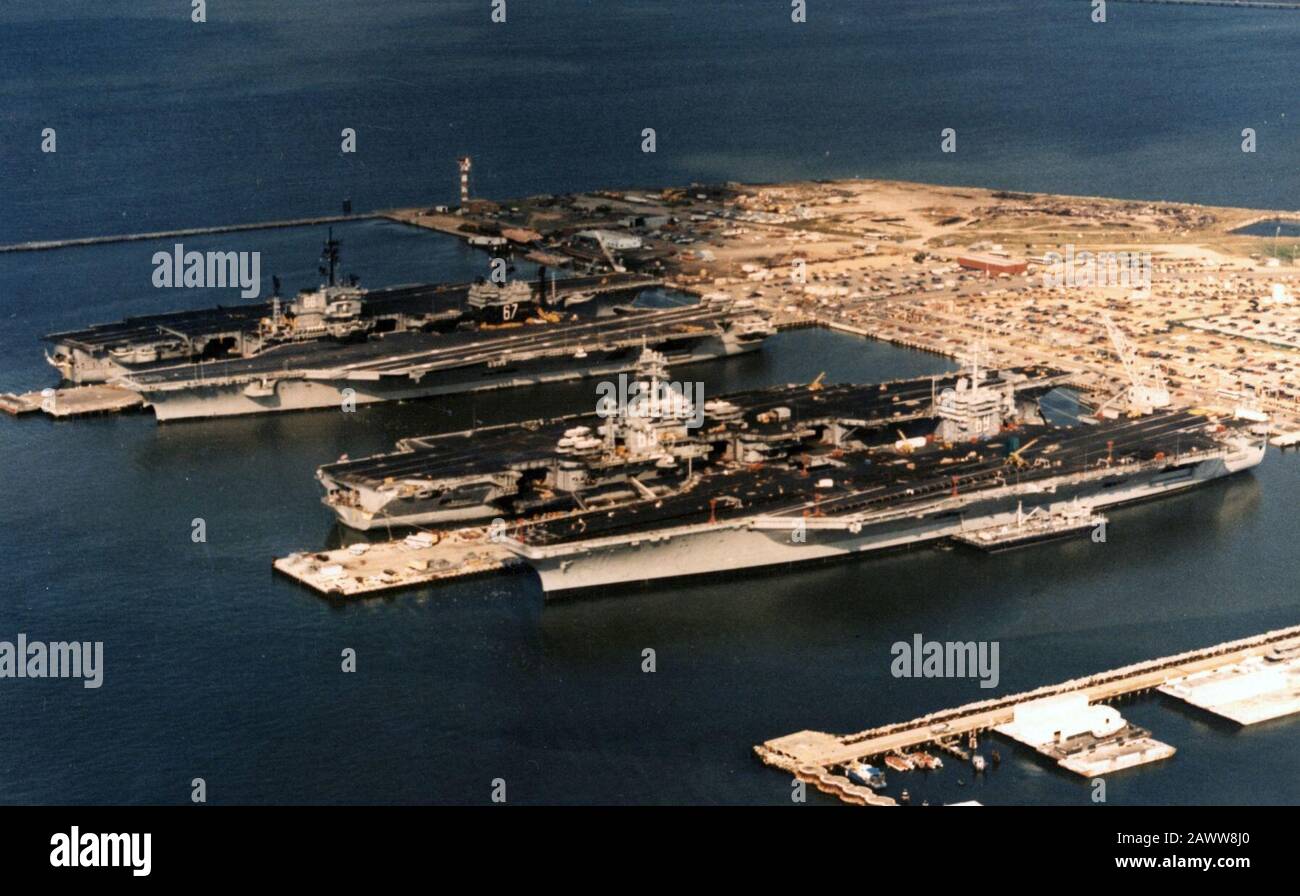 Four US Navy carriers at Norfolk Naval Station 1985 Stock Photo - Alamy