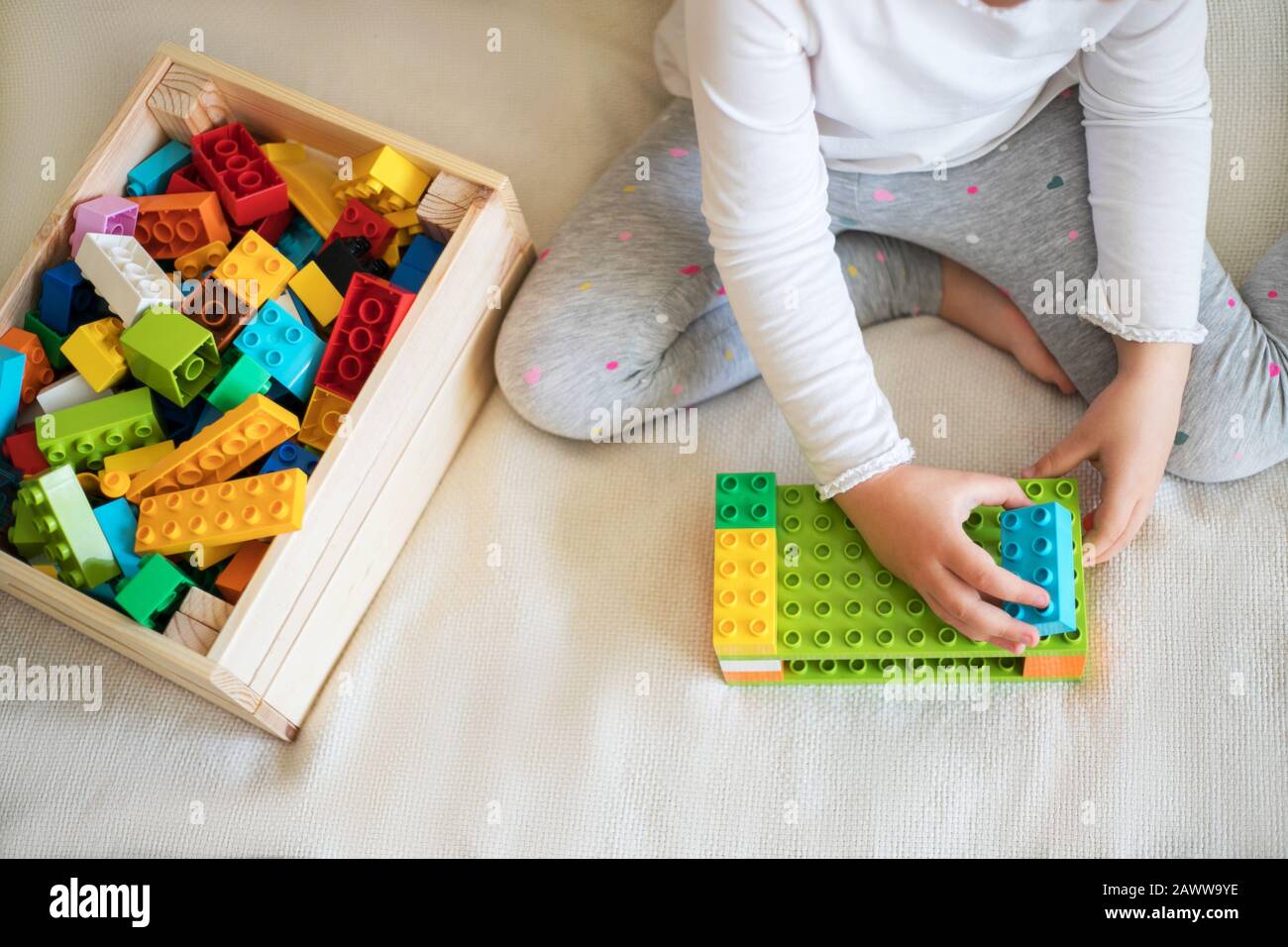 Little girl playing with her colorful blocks in her room Stock Photo ...