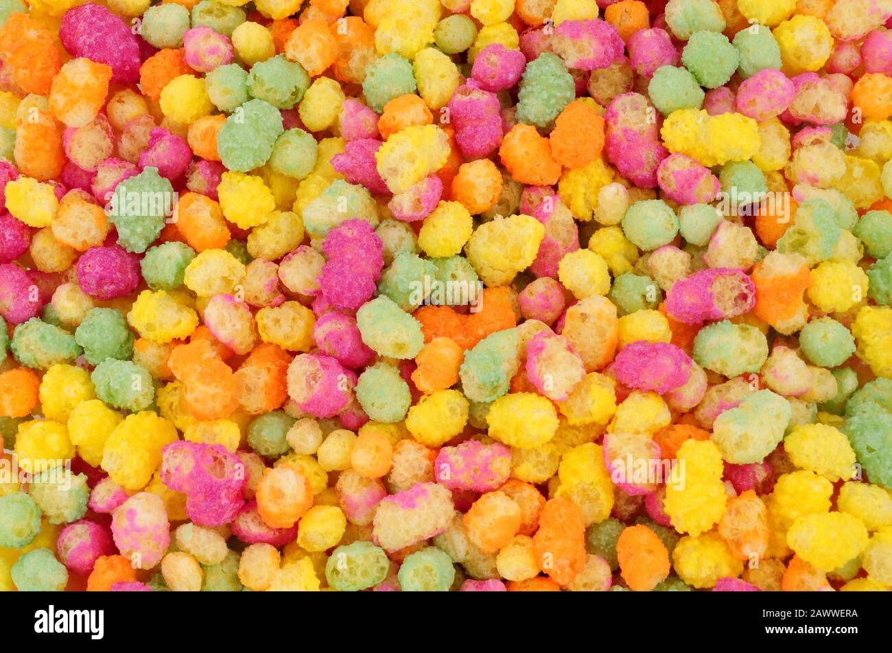 Rainbow coloured puffed maize and rice confectionery background Stock ...