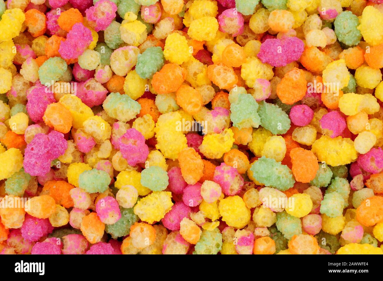 Rainbow coloured puffed maize and rice confectionery background Stock ...