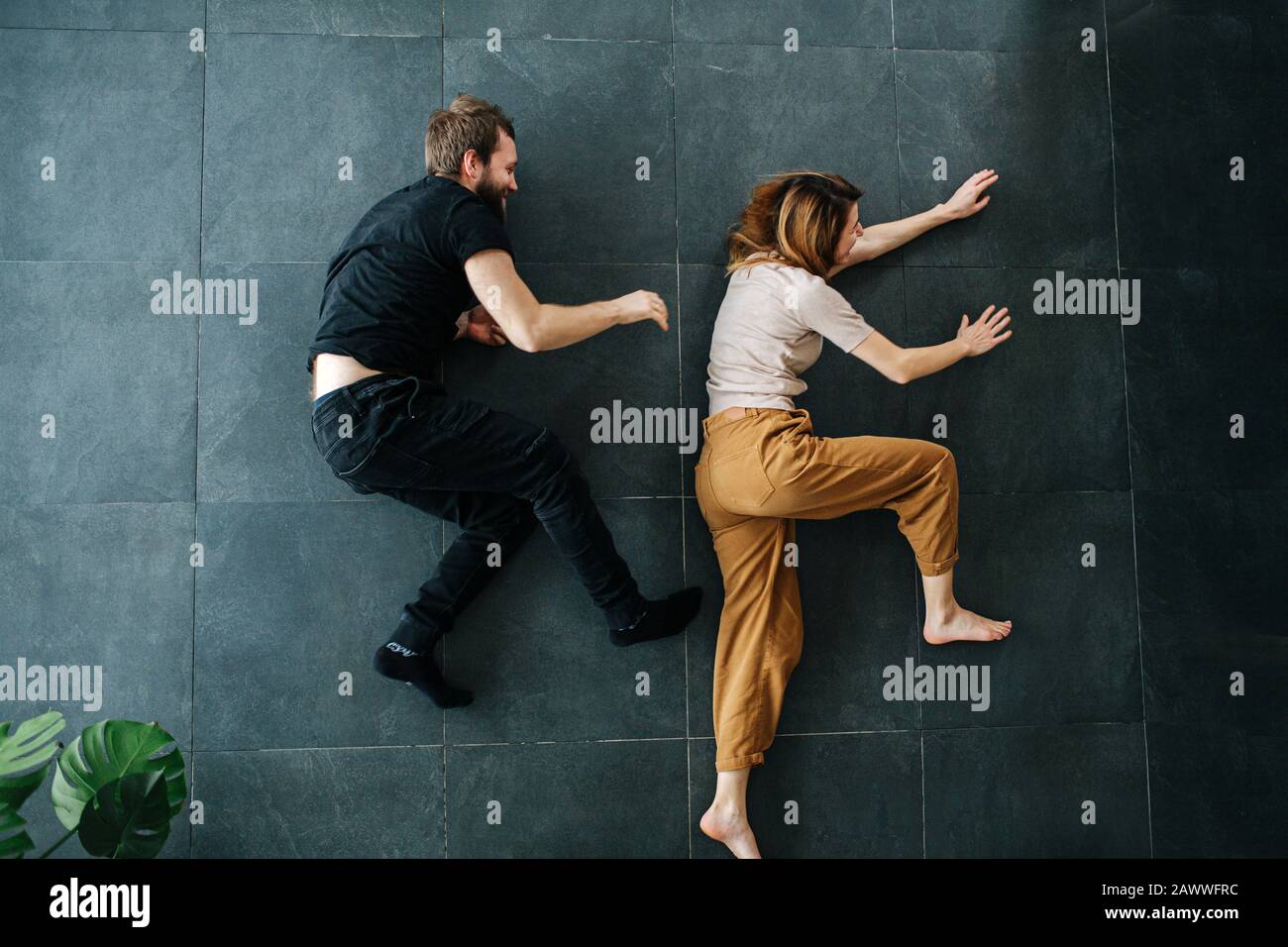Couple playing chase scene, running while lying on the floor Stock ...