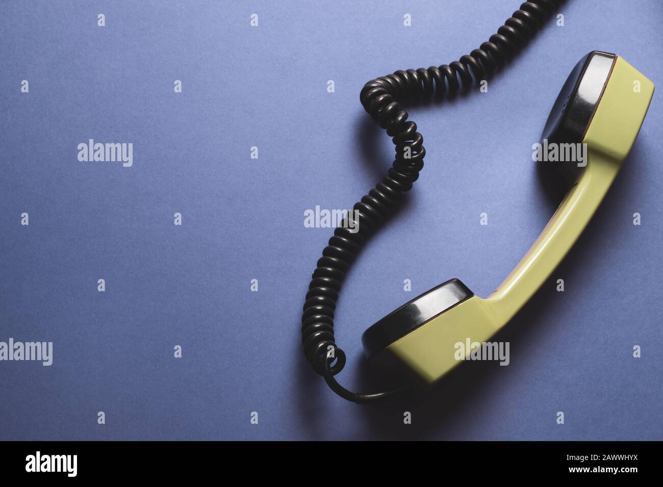 Vintage green telephone handset. phone receiver isolated on blue ...