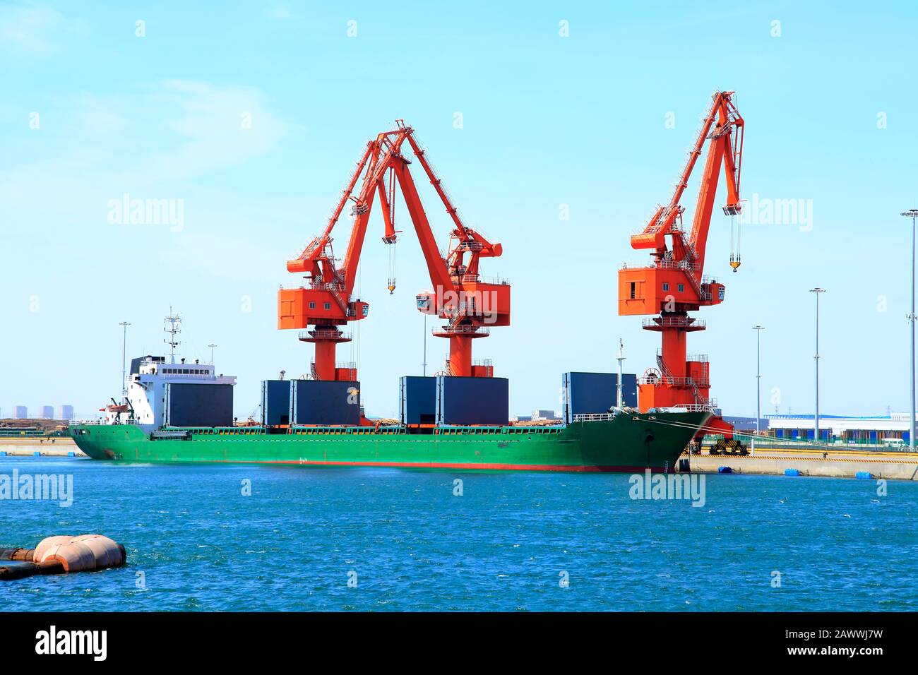 In freight terminal, gantry crane and cargo ships are in loading and ...