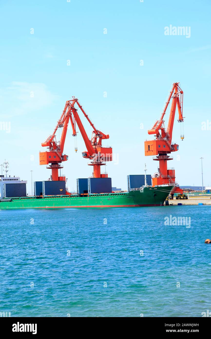 In freight terminal, gantry crane and cargo ships are in loading and ...