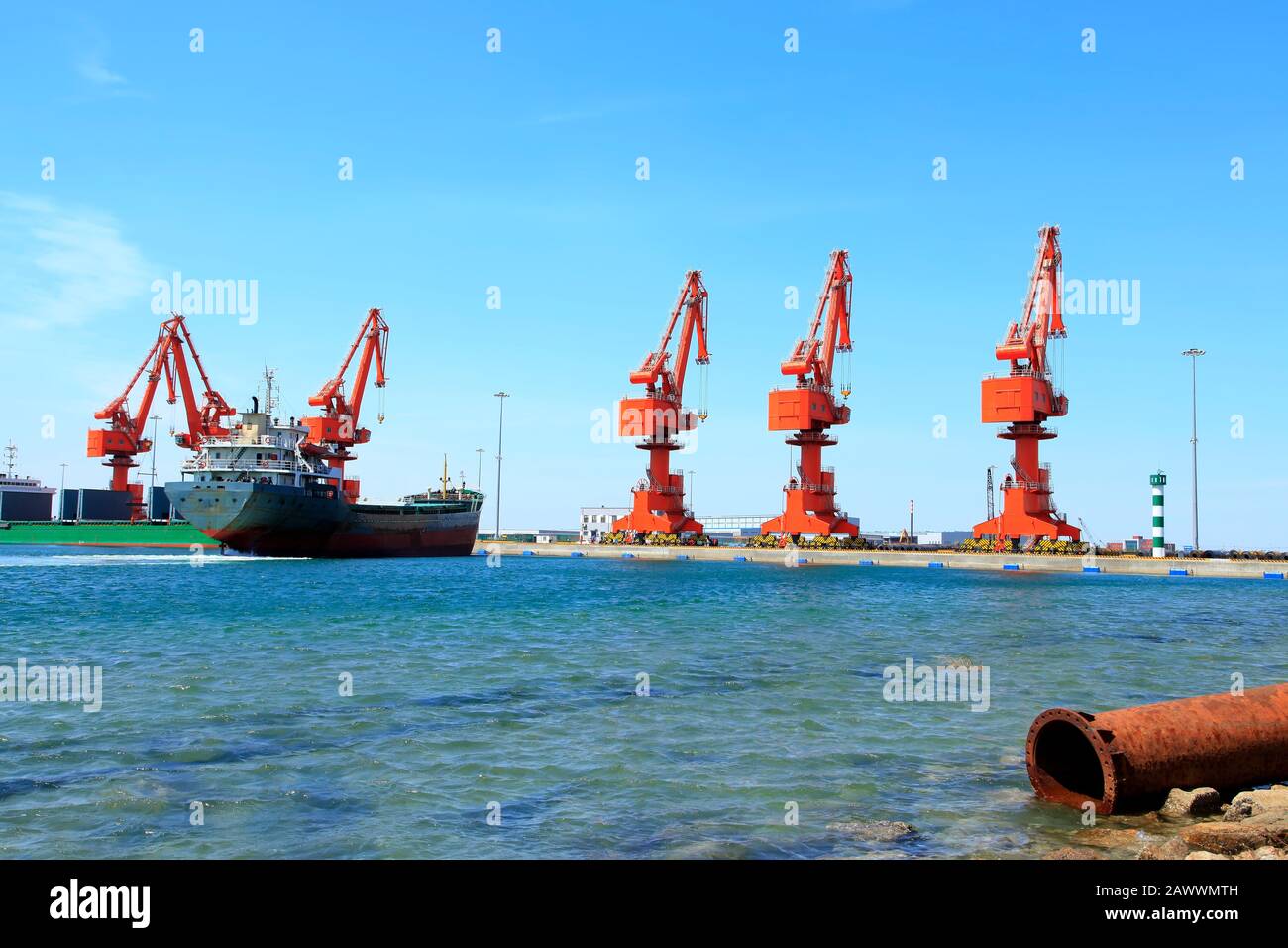 In freight terminal, gantry crane and cargo ships are in loading and ...