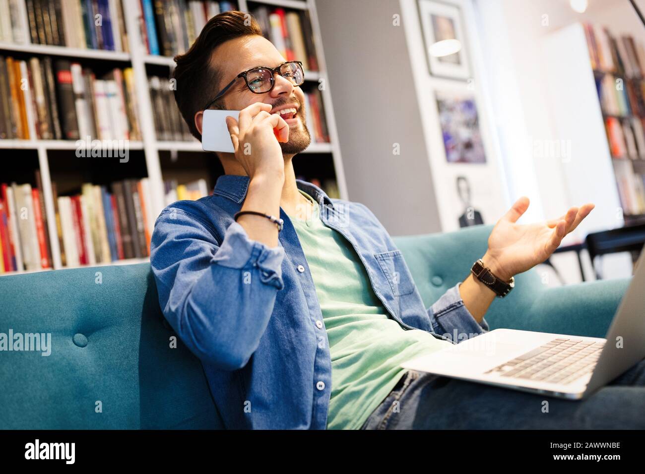 Working with pleasure. Happy man talking on the mobile phone and ...