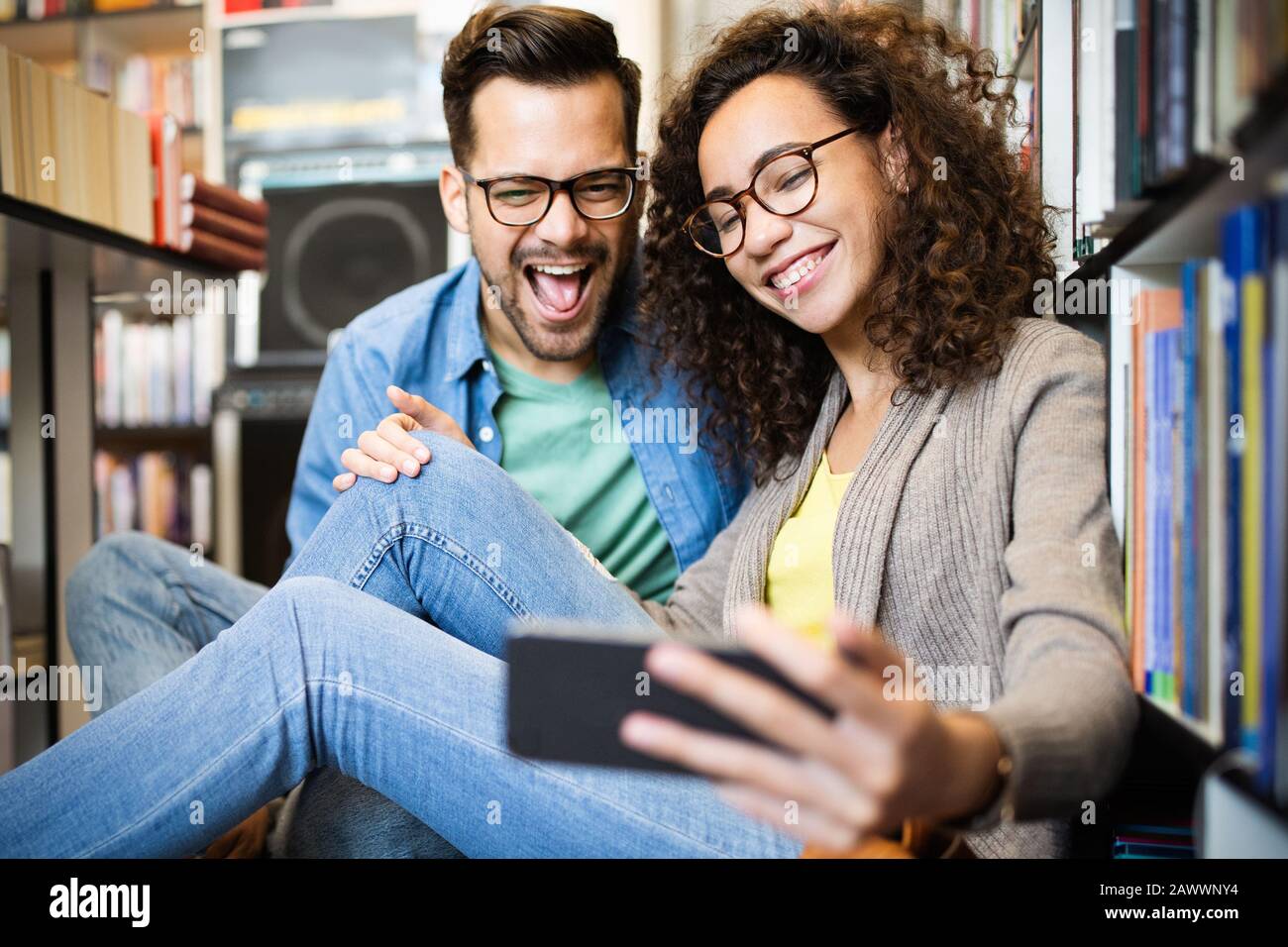 Students are studying together in library. Couple, study, technology ...