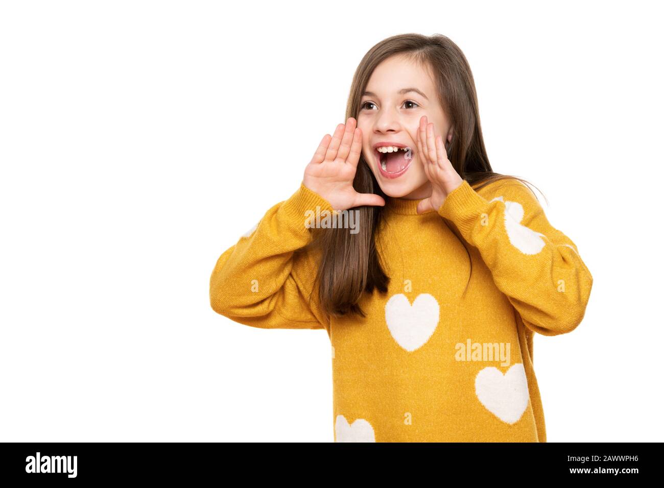 Studio portrait of an adorable young girl screaming with excitement ...