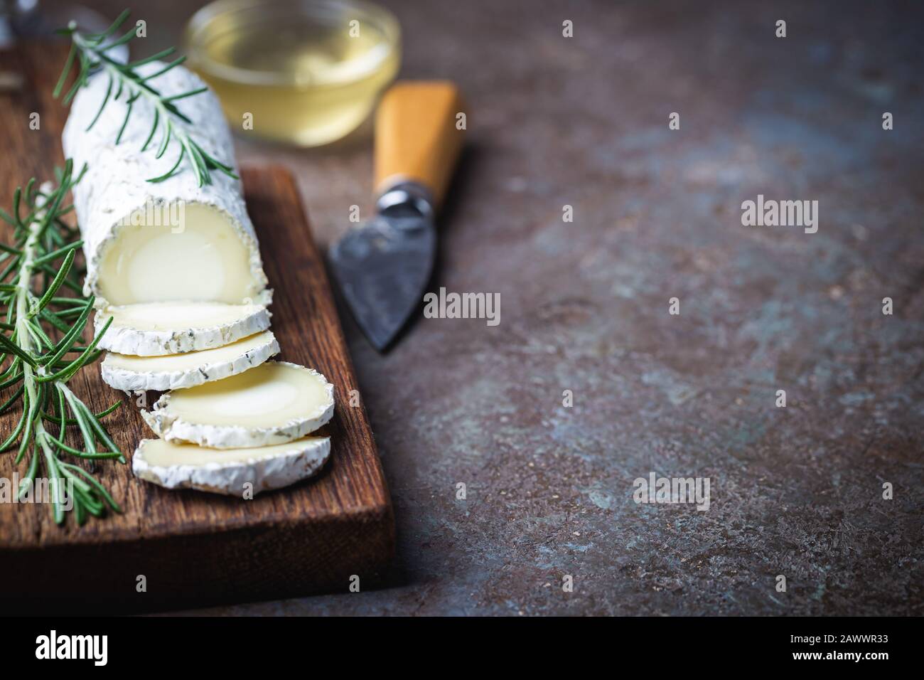 Fresh goat brie cheese with truffle and white mold on cheese platter ...