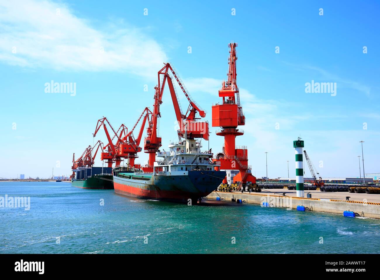 In freight terminal, gantry crane and cargo ships are in loading and ...