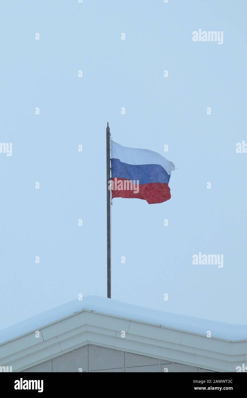 Russian flag on a blue sky background. White, blue and red tricolor ...