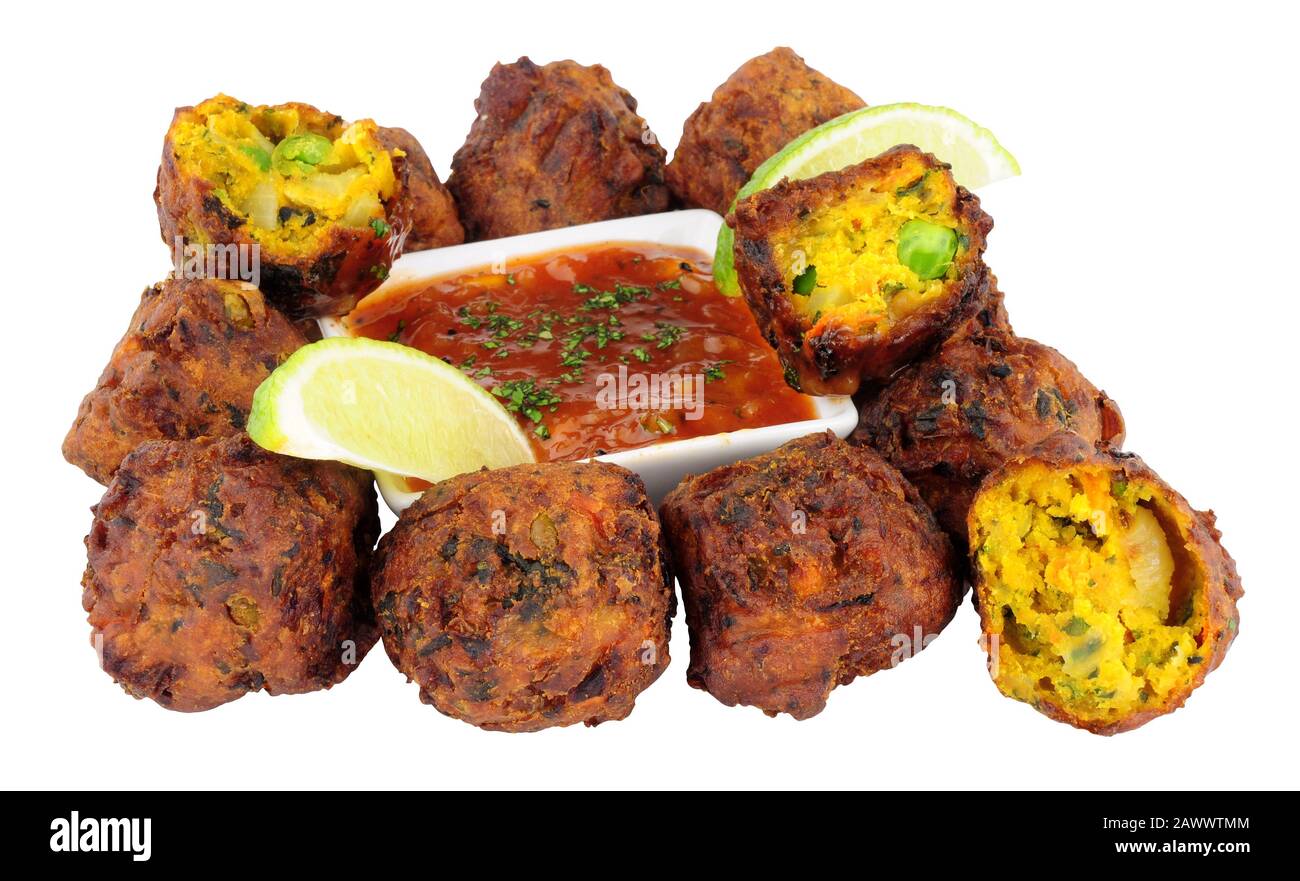 Group of fried vegetable pakora with chilli sauce dip isolated on a ...