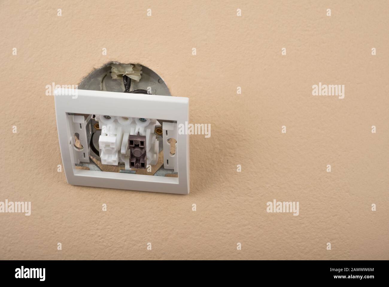 White electric switch with on a wall and without cover Stock Photo - Alamy