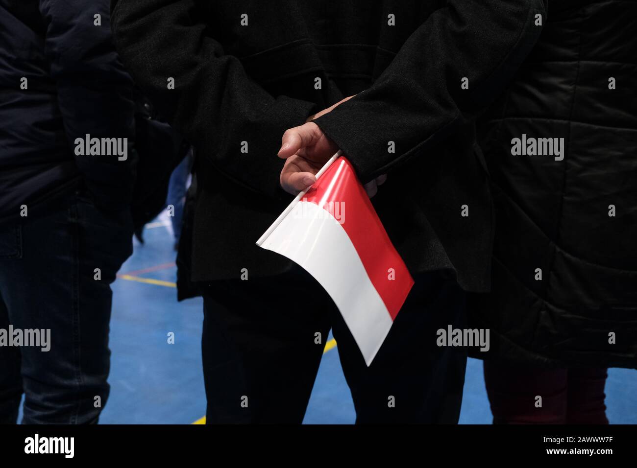 white and red flag Polish flag hold in hand Stock Photo - Alamy