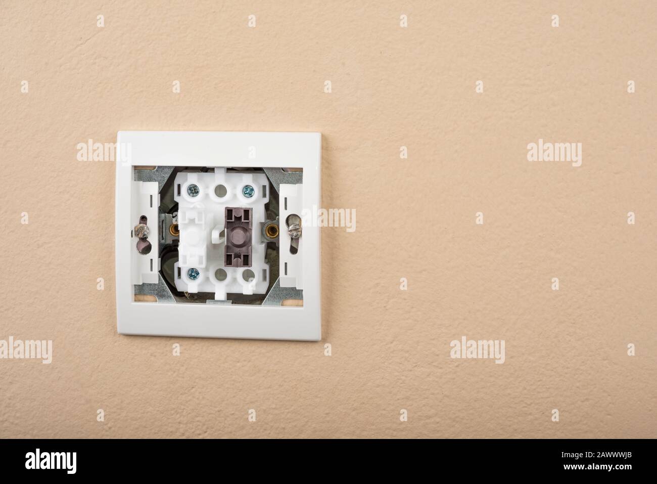 White electric switch with on a wall and without cover Stock Photo - Alamy