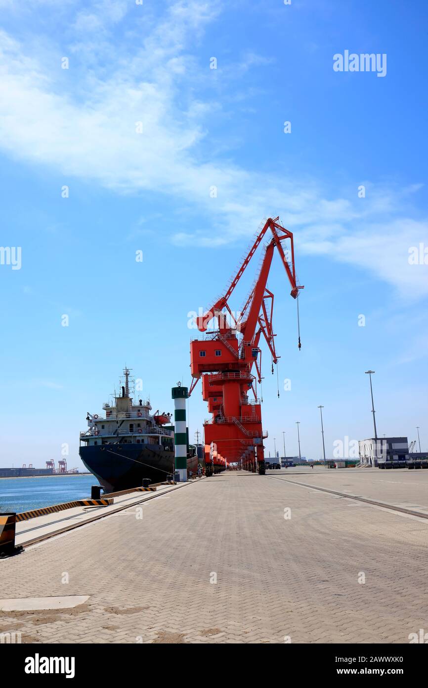 In freight terminal, gantry crane and cargo ships are in loading and ...