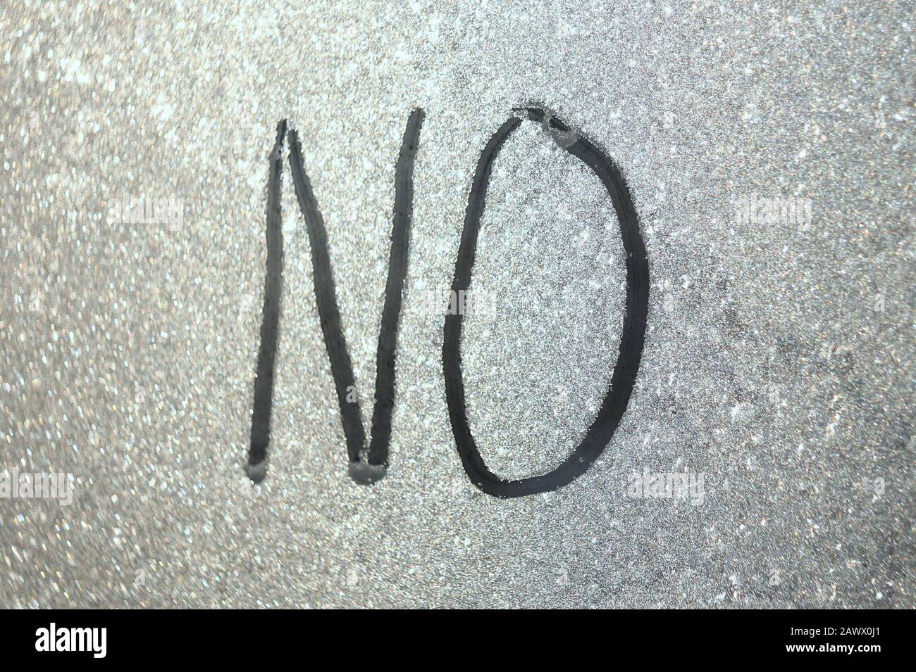 The inscription on frozen window pane. Word no written on blurry ...