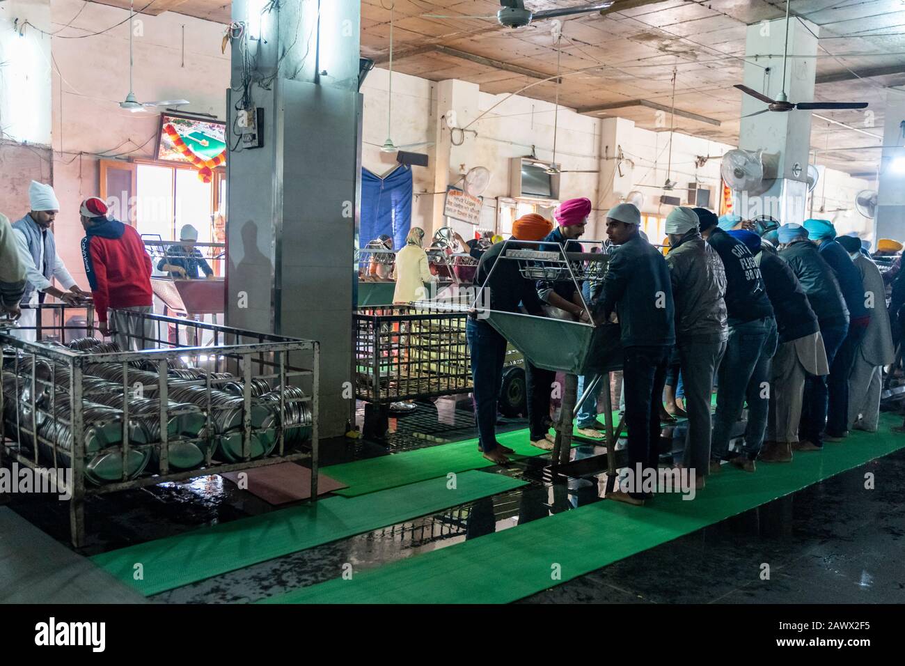 Amritsar India - Febuary 8, 2020: Volunteers wash dishes at the kitchen ...
