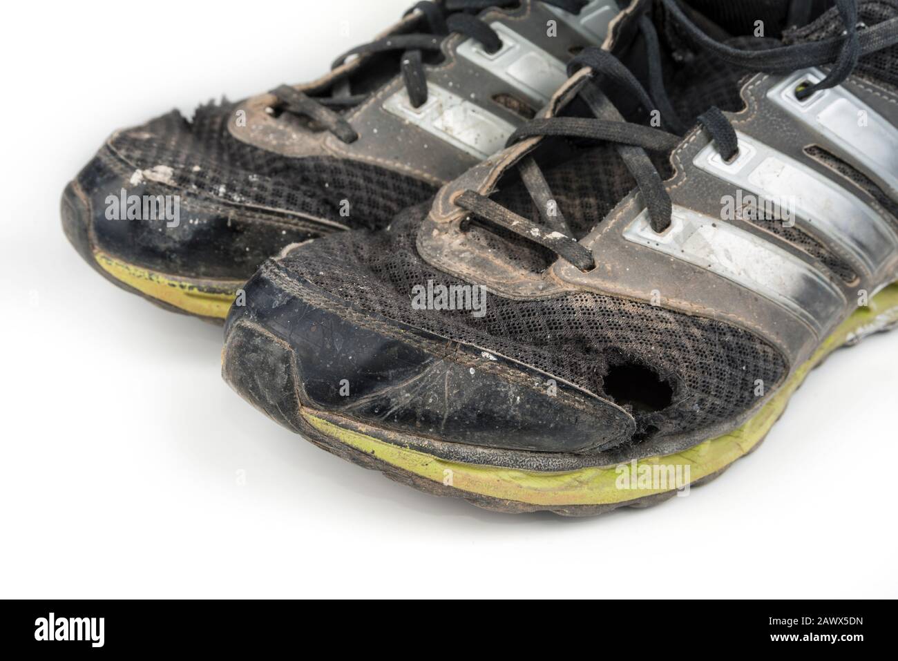 Old used sneakers. Torn training shoes Stock Photo - Alamy