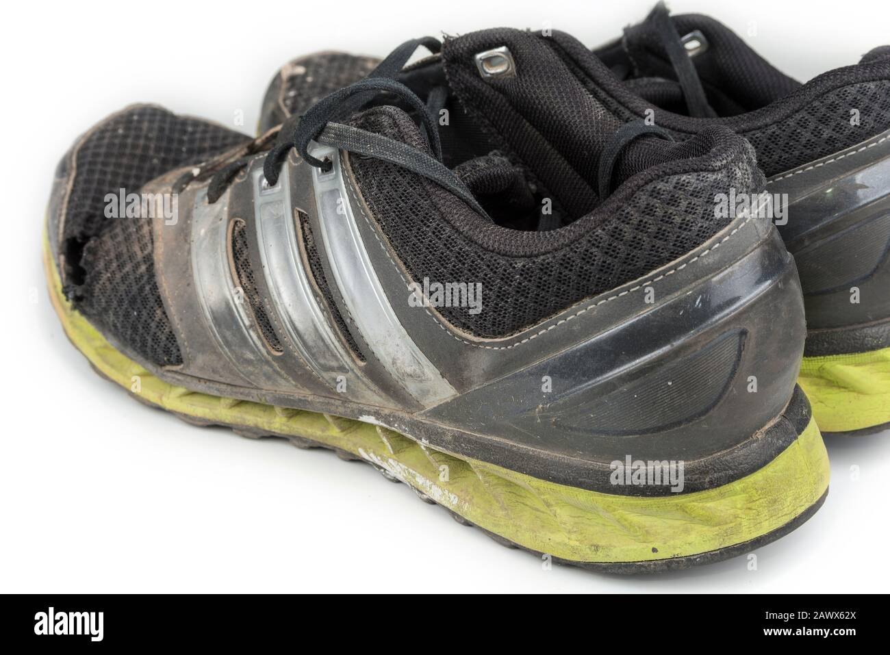 Old used sneakers. Torn training shoes Stock Photo - Alamy
