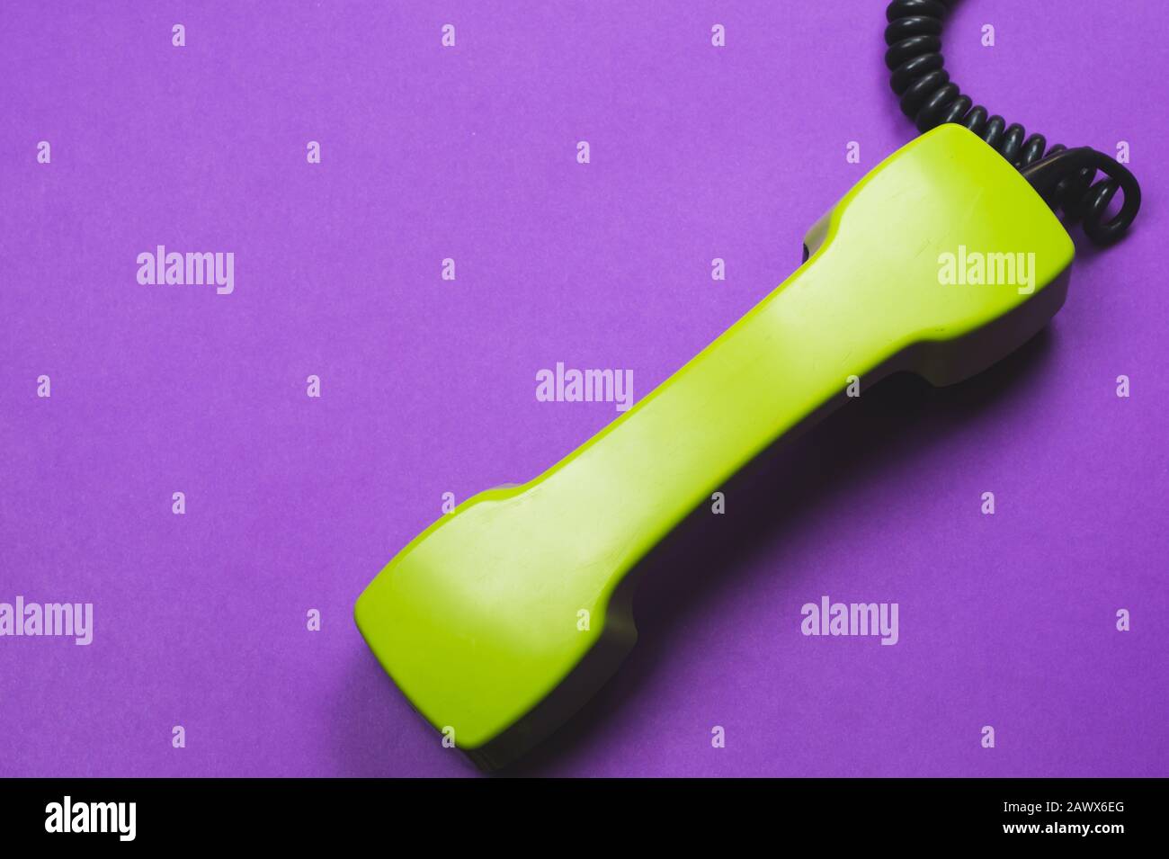 Vintage green telephone handset. phone receiver isolated on purple ...