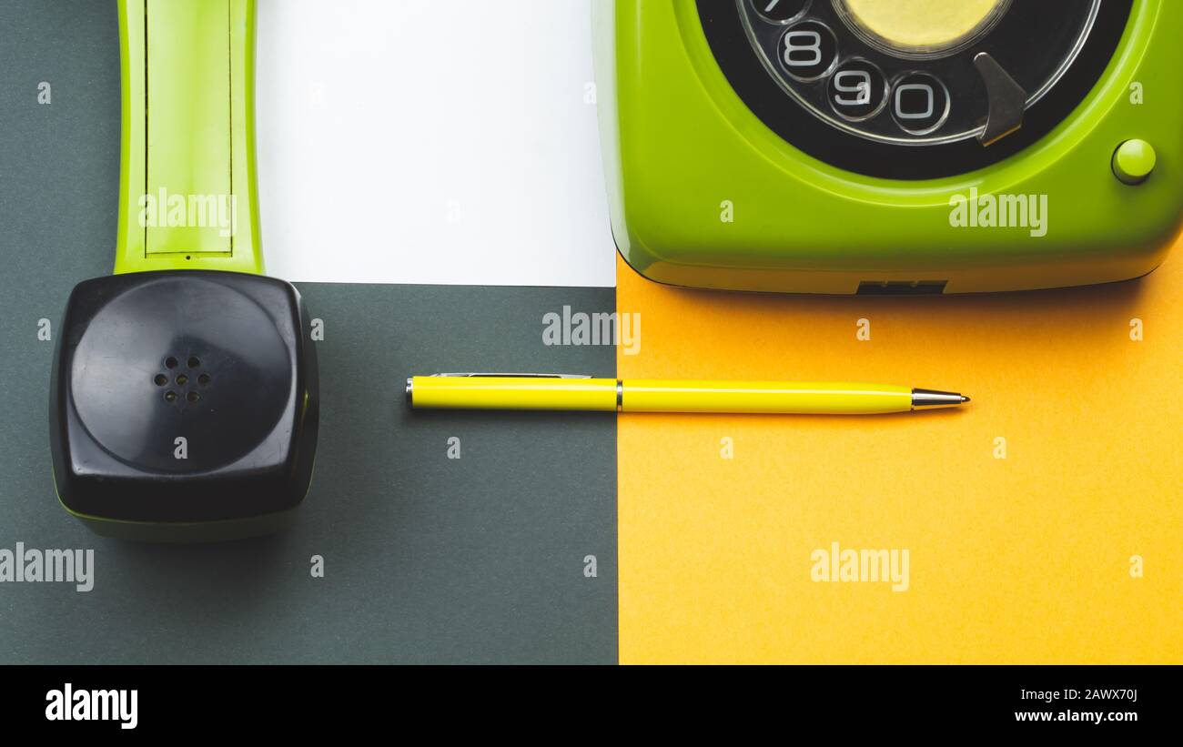 Classic phone with handset. pen with a note. office background. vintage ...