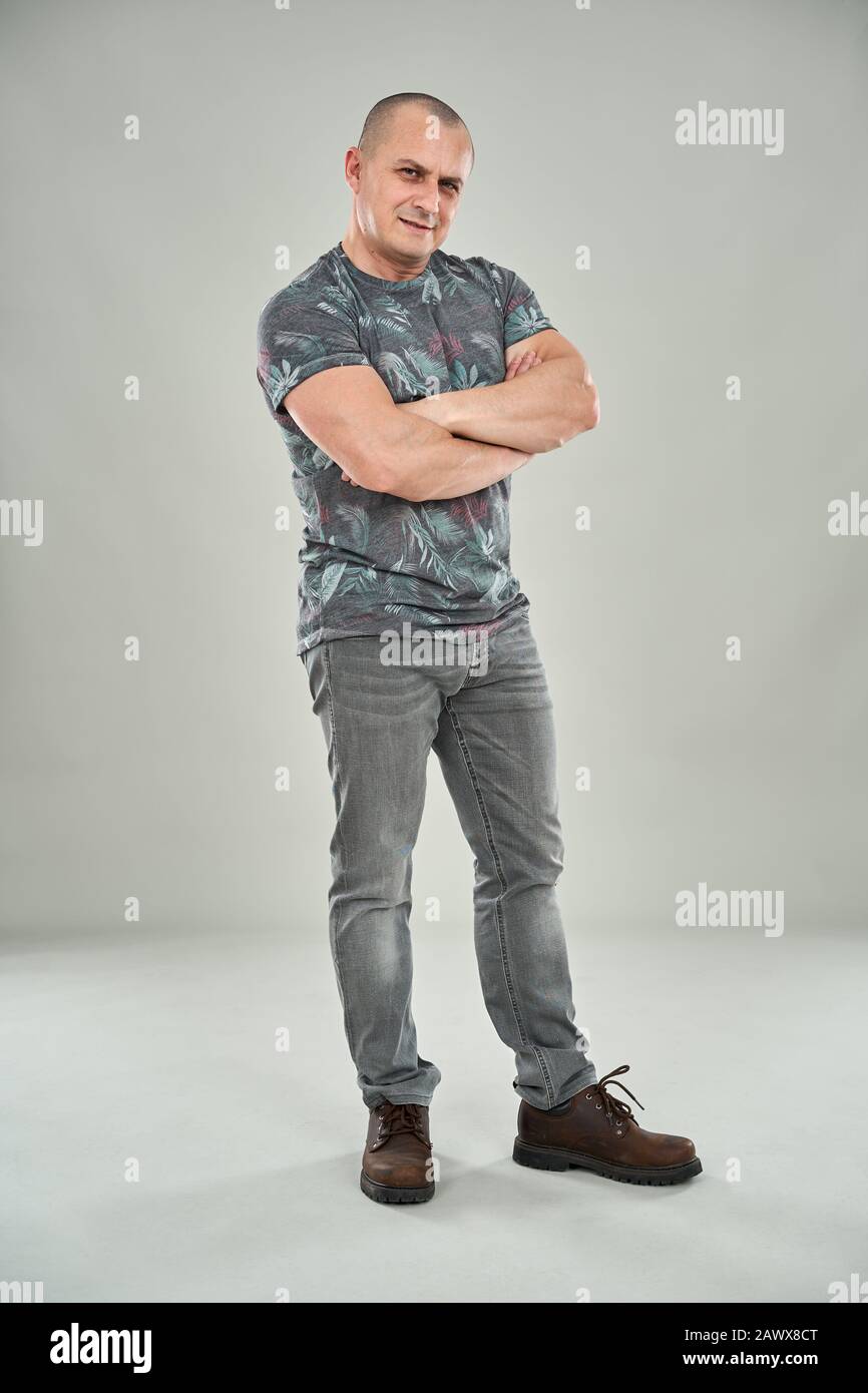 Full length portrait of a man with arms folded Stock Photo - Alamy