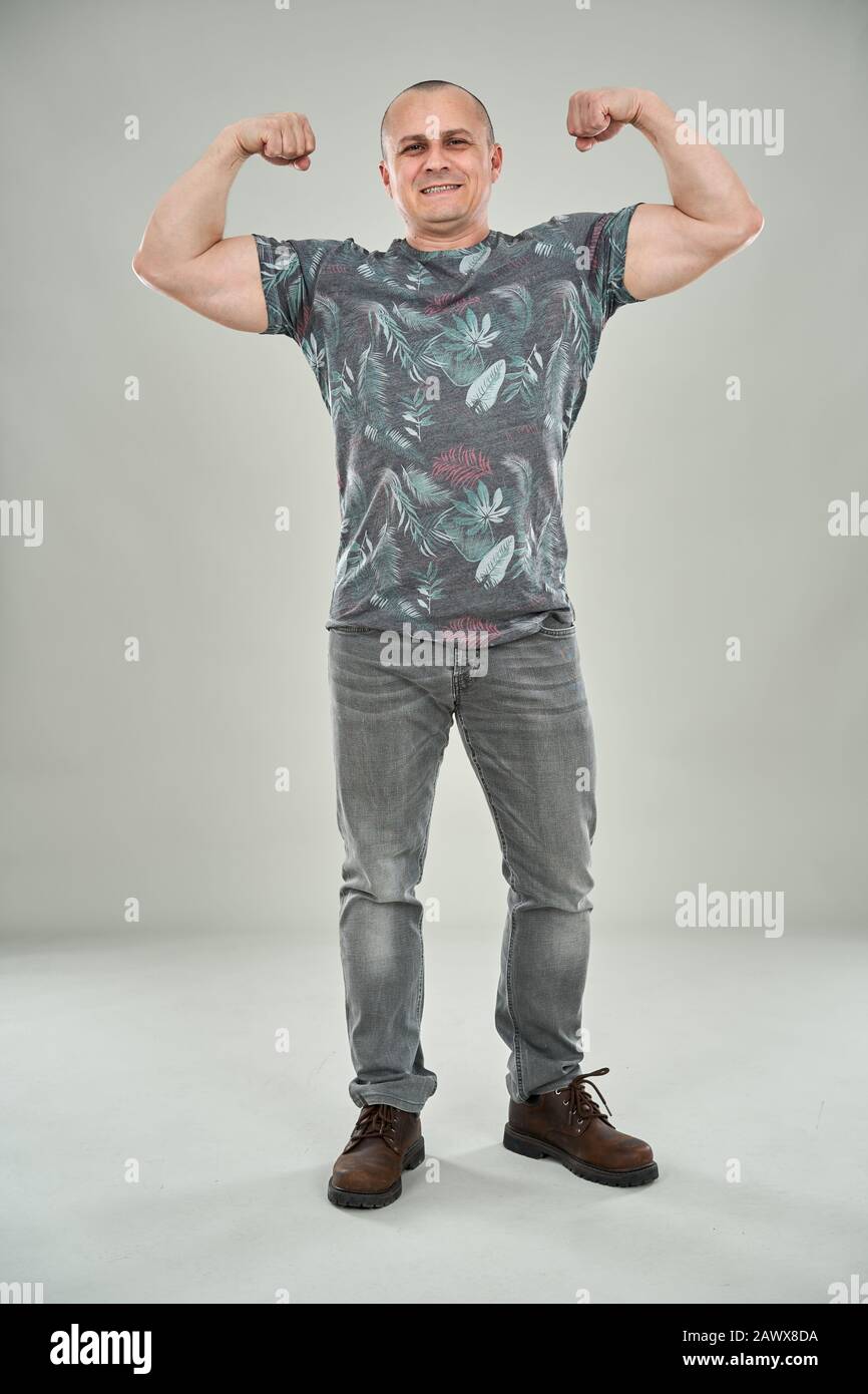 Strong businessman showing off his muscles Stock Photo - Alamy