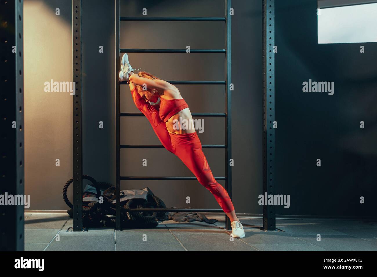 Vitality. Young muscular caucasian woman practicing in gym. Athletic ...