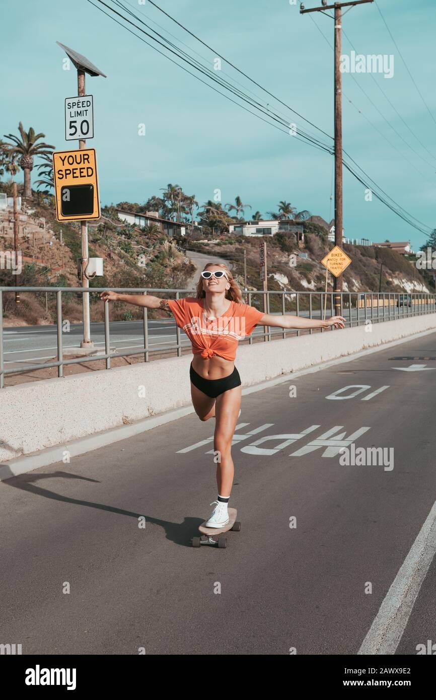 skater girl skating on street in malibu Stock Photo - Alamy