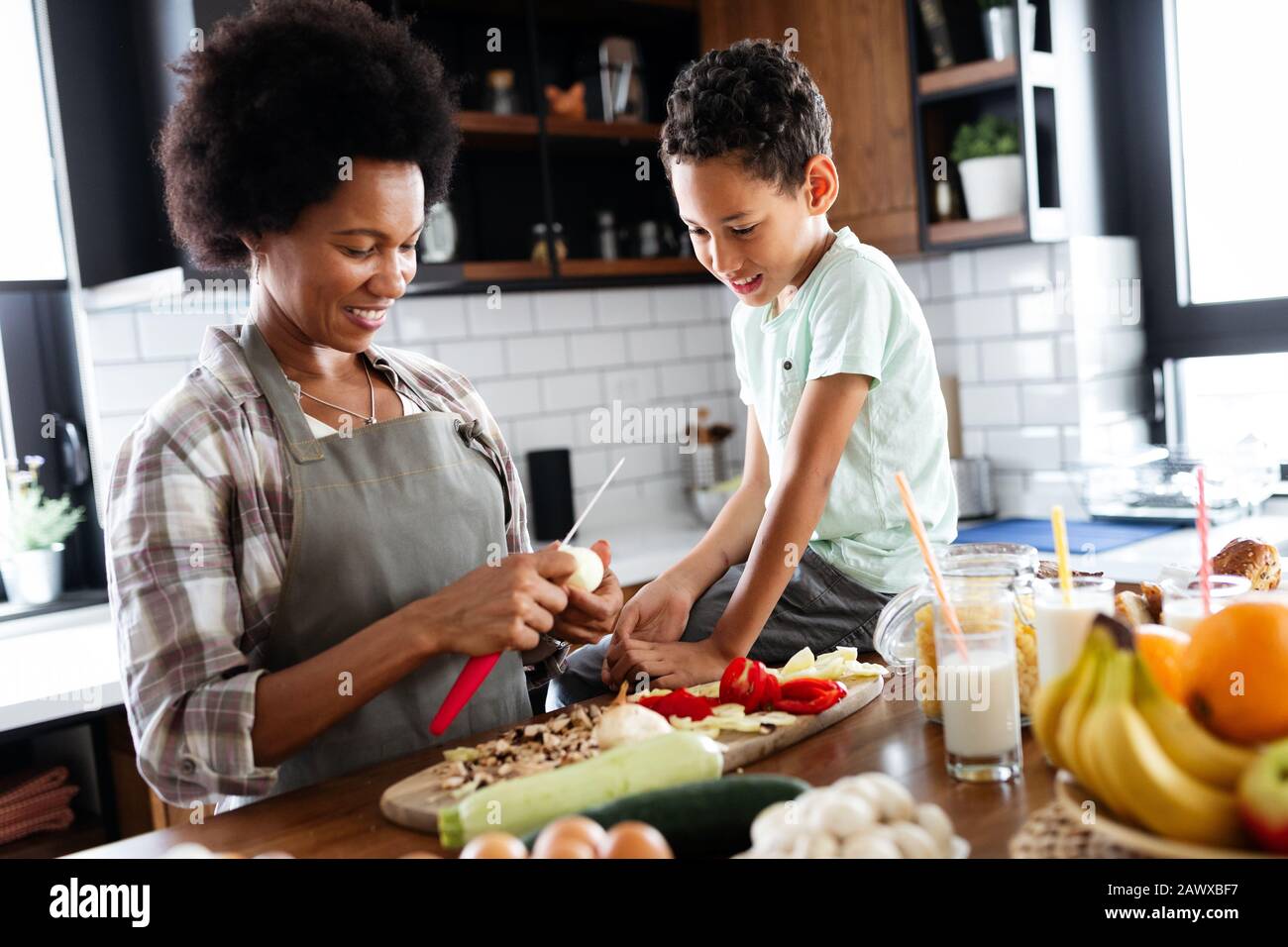 Mother and child having fun preparing healthy food in kitchen Stock ...