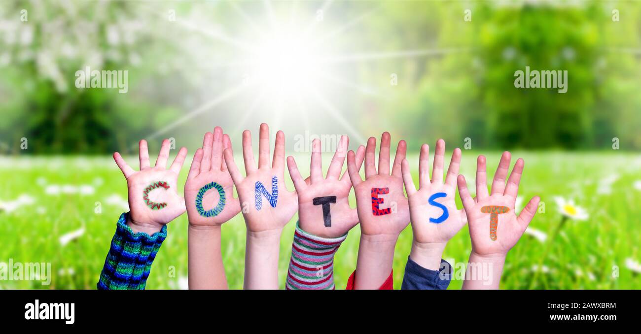 Children Hands Building Word Contest, Grass Meadow Stock Photo - Alamy