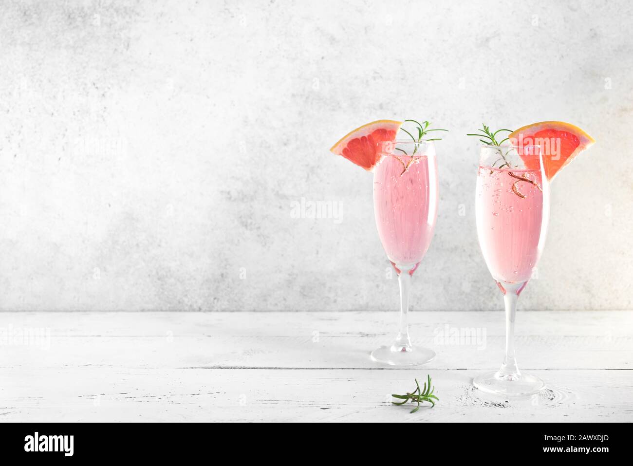 Mimosa cocktail with Champagne, Grapefruit and Rosemary in flute ...