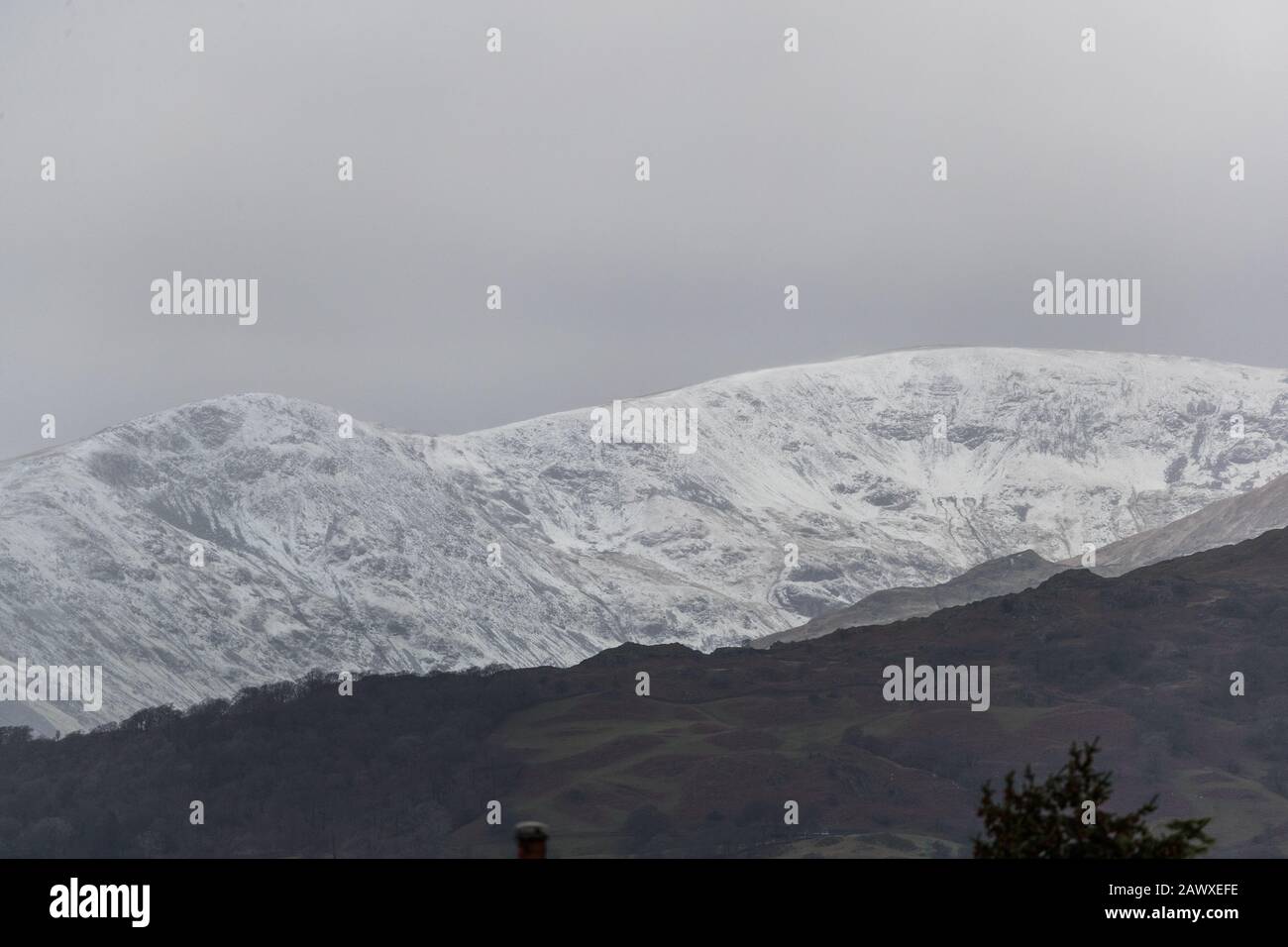 Cumbria, UK. , . UK weather . Snow on fells above the northern end of ...