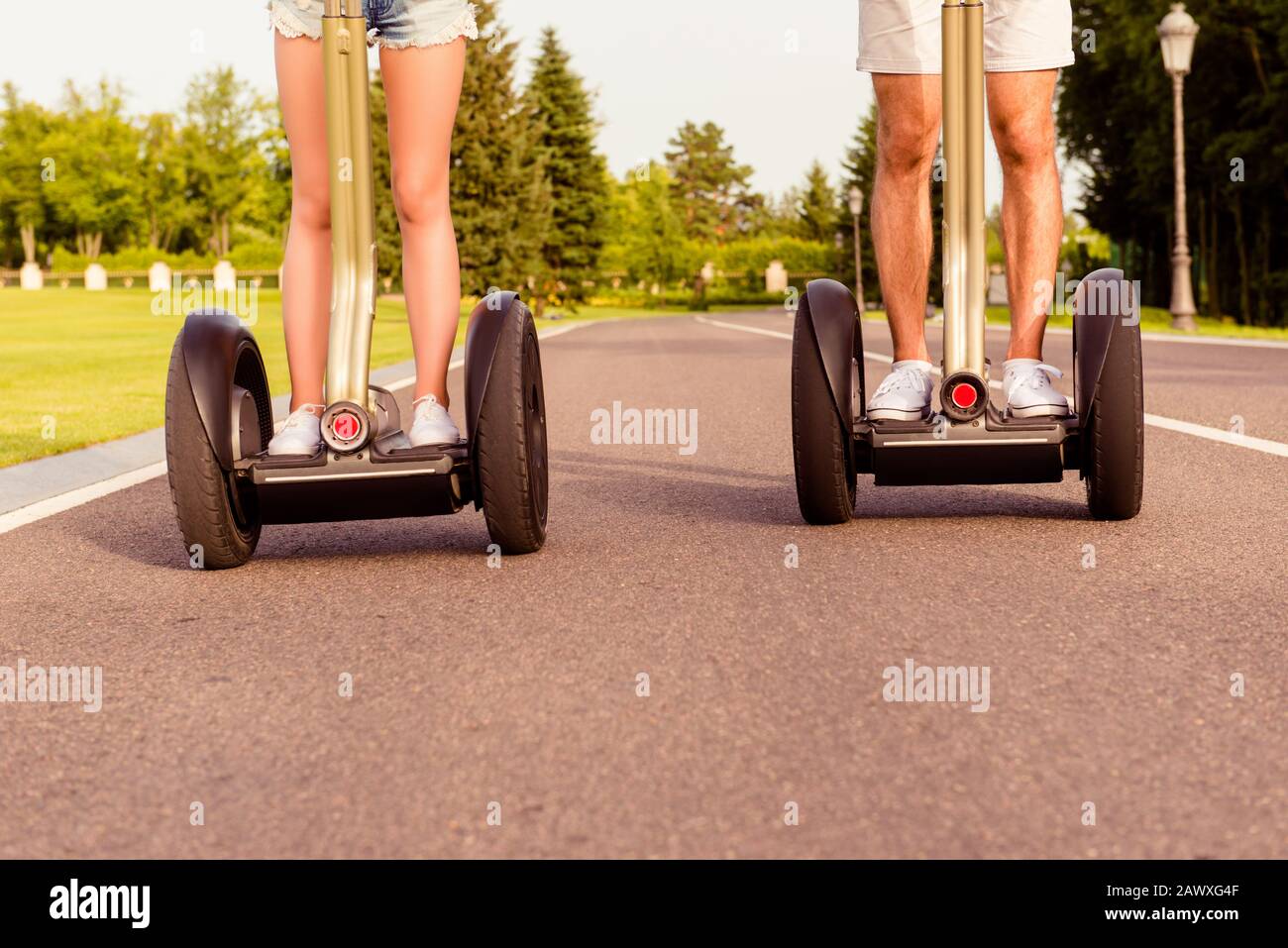 Close up photo of man and woman riding electric gyropode Stock Photo ...