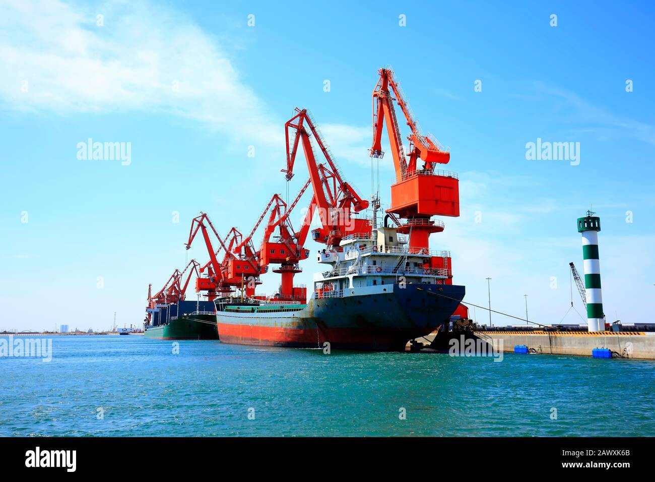 In freight terminal, gantry crane and cargo ships are in loading and ...