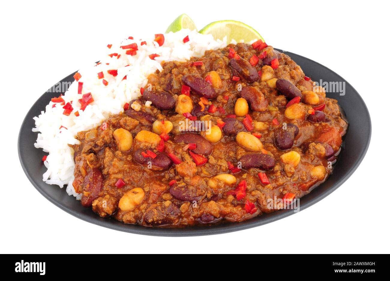 Chilli Con Carne with boiled rice on a black plate isolated on a white ...