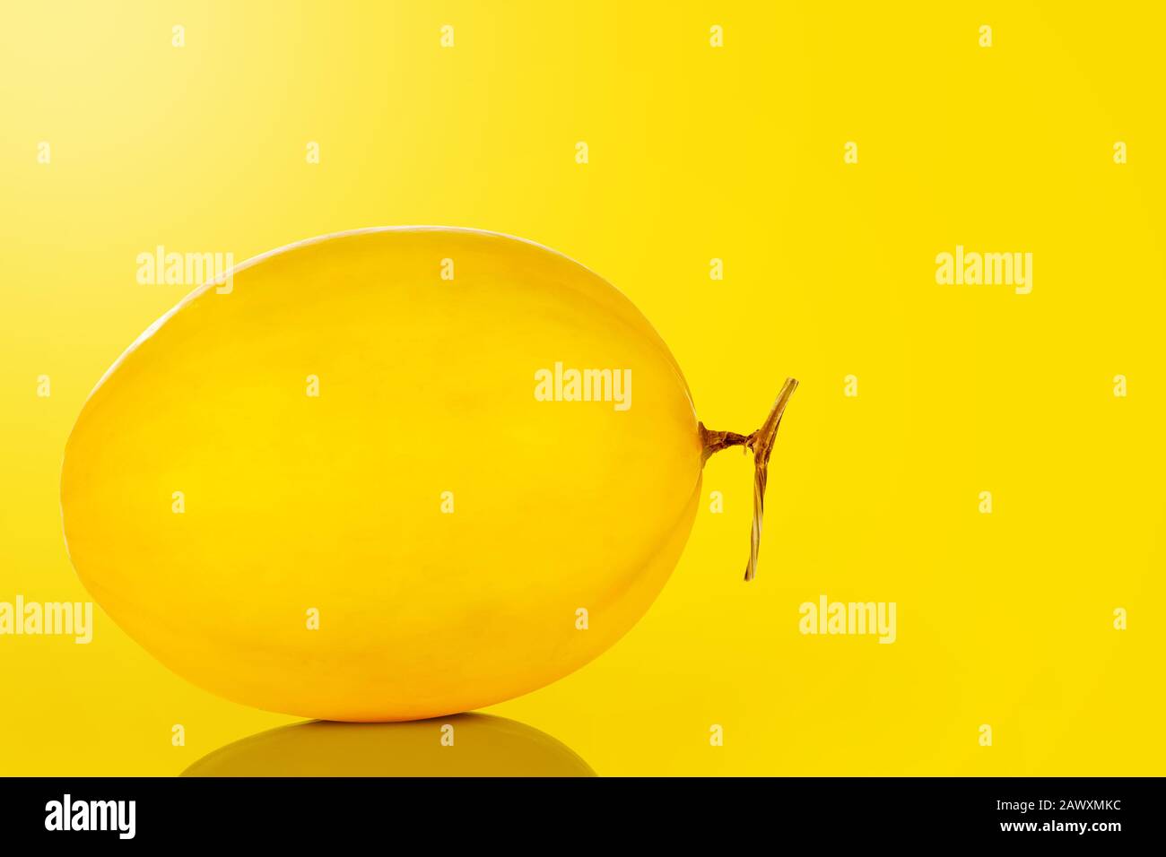 Canary melon in vibrant color on yellow background Stock Photo - Alamy