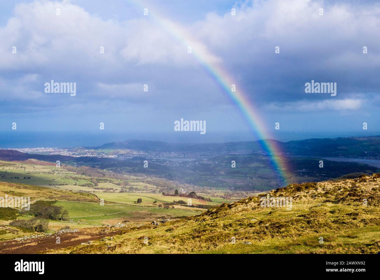 Rainbow on Tal y Fan mountain during changeable weather before storm ...