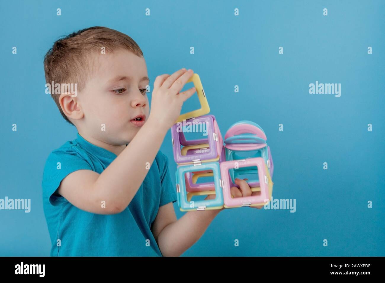 Boy looks through the shape in the color constructor with the ...
