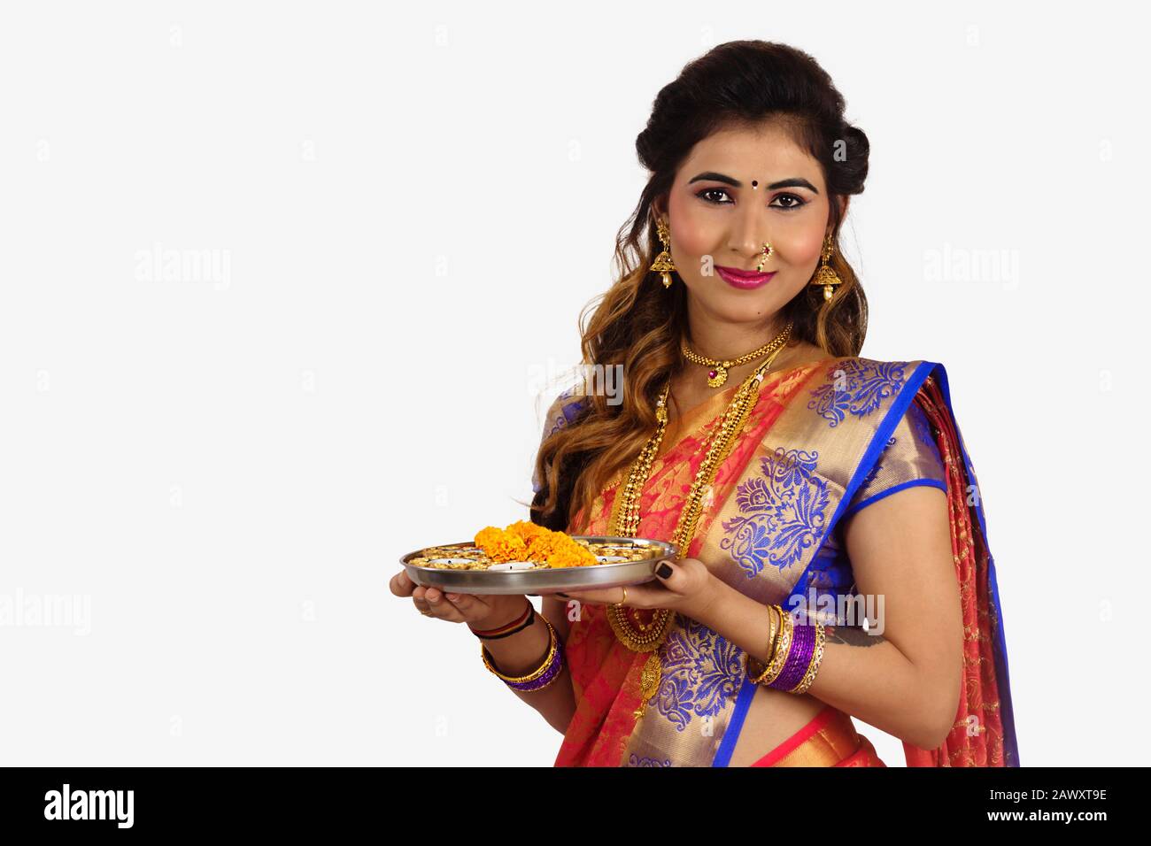 Indian Model wearing traditional Maharashtrian silk saree, holding puja ...