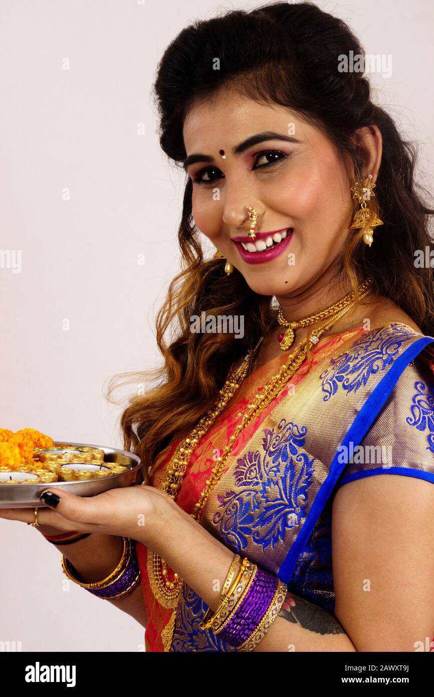 Indian Model wearing traditional Maharashtrian silk saree, holding puja ...