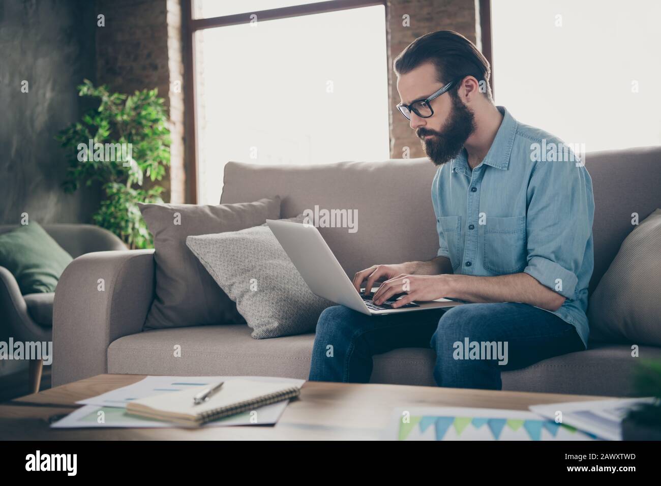 Portrait of his he nice attractive serious focused brunet guy sitting ...