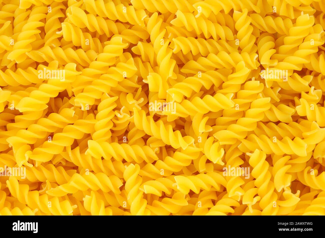 Dried uncooked Eliche pasta spiral shape background Stock Photo - Alamy