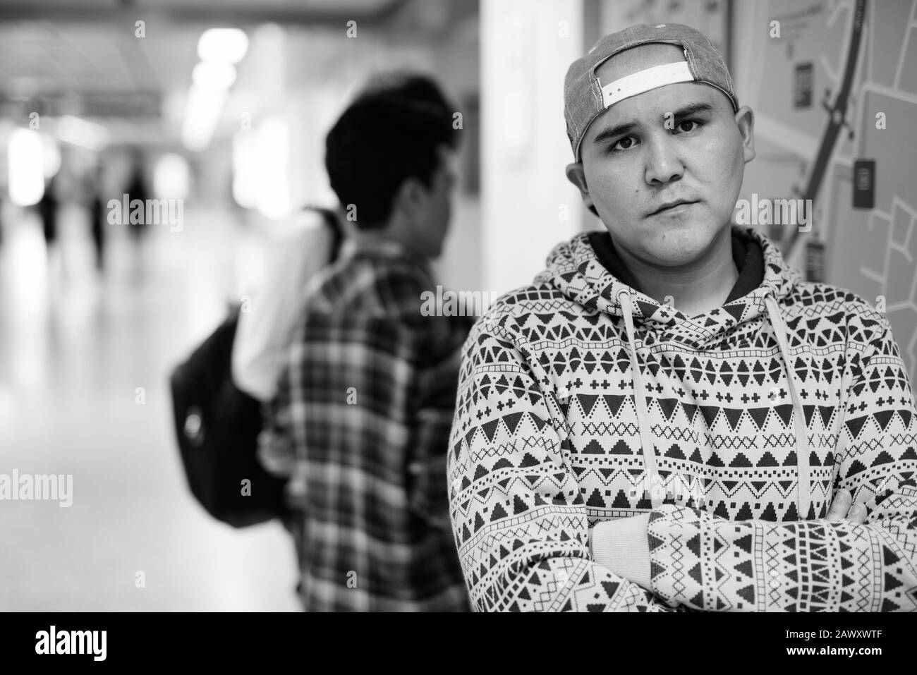 Three young Asian men inside the subway train station Stock Photo - Alamy