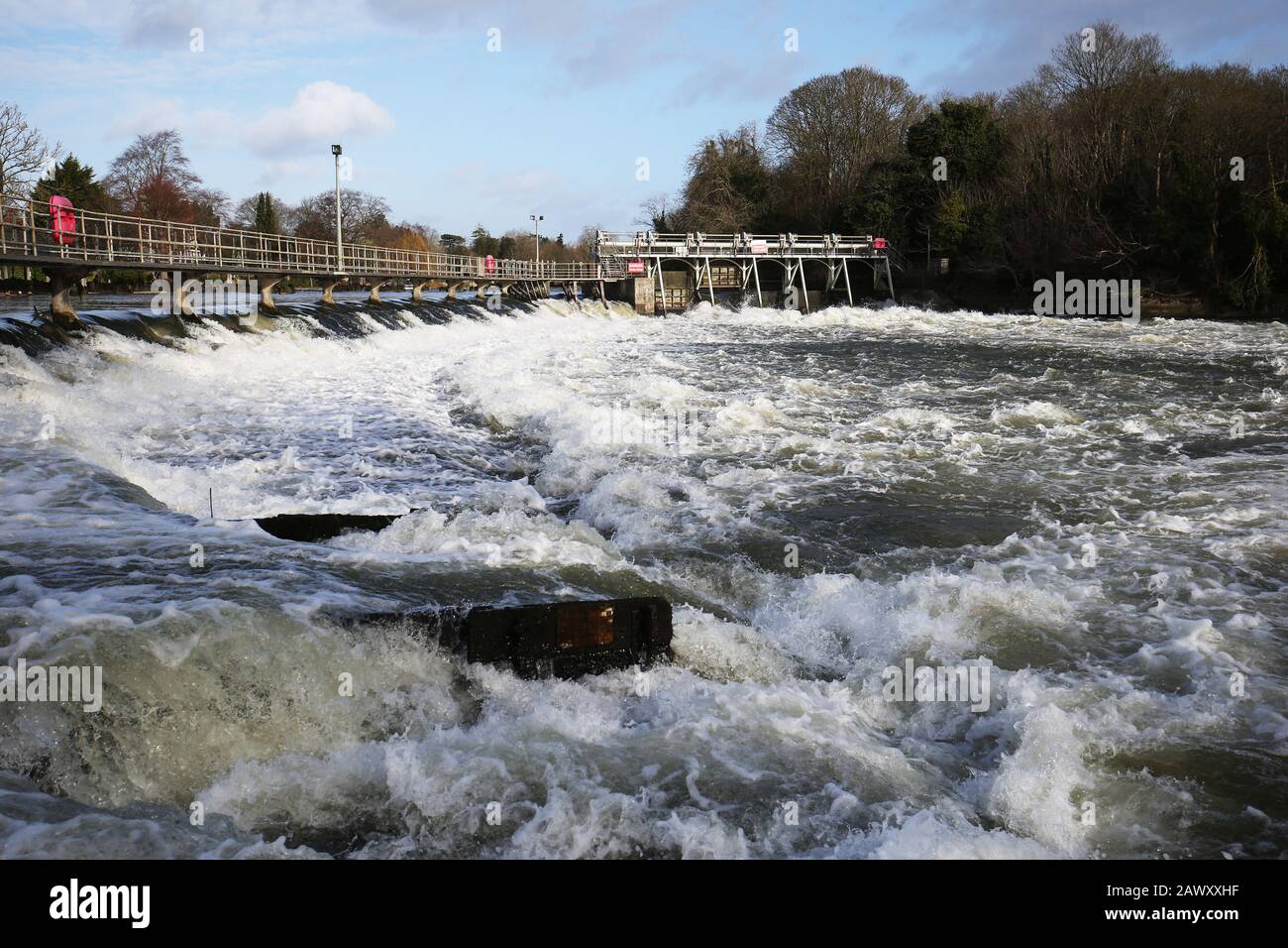 Fast flowing water passes through the weir at Ray Mill Island ...